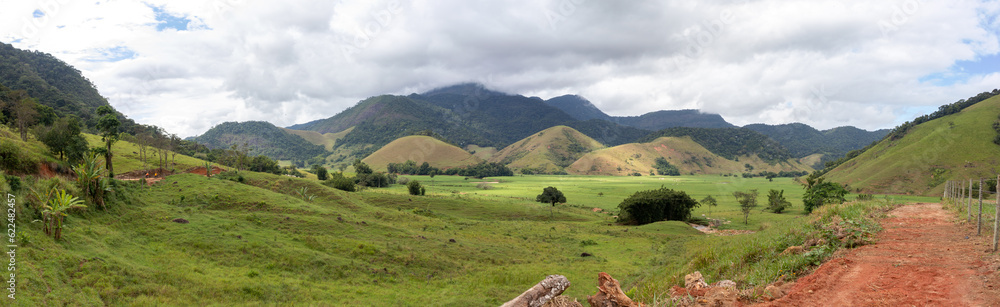 Panorama of mountainous terrain with forest and small houses. Panoramic ...