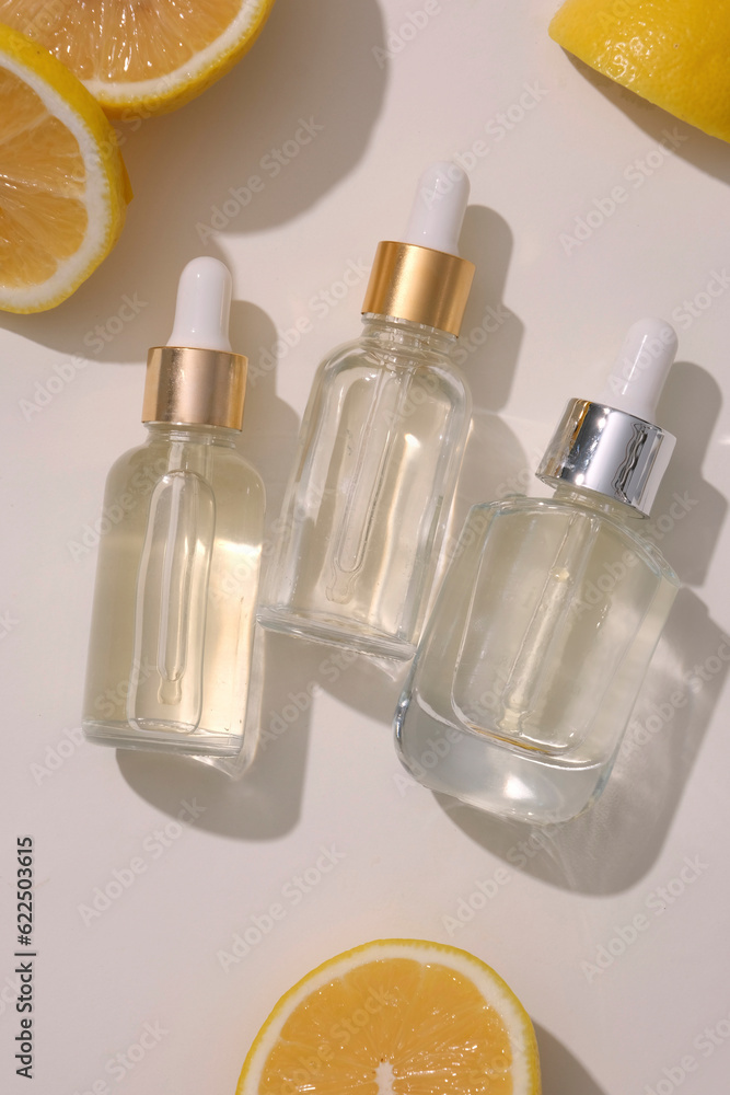 Three transparent glass dropper bottles without label arranged on white ...