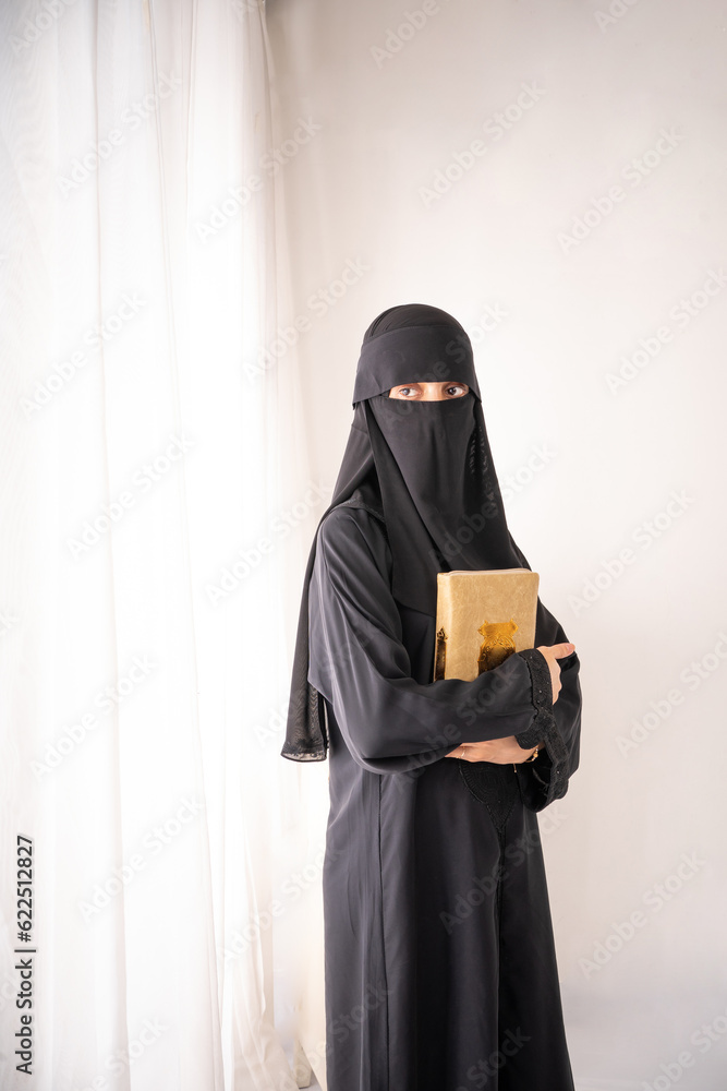 muslim woman wearing a black hijab or niqab and long black dress ...