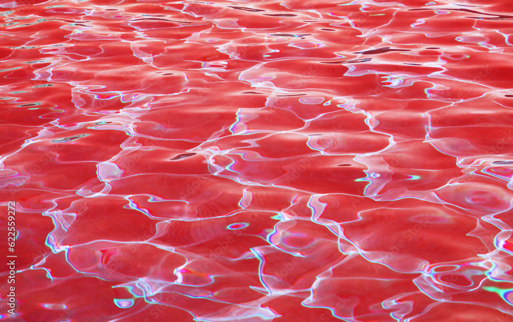 Eye-catching surreal pop art of red colored water surface reflecting ...