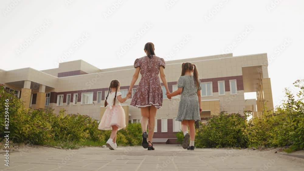 mother takes two daughters school lessons. sister girls with school ...