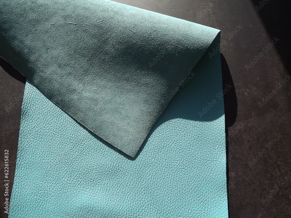 Genuine leather and genuine suede turquoise blue close-up as background ...