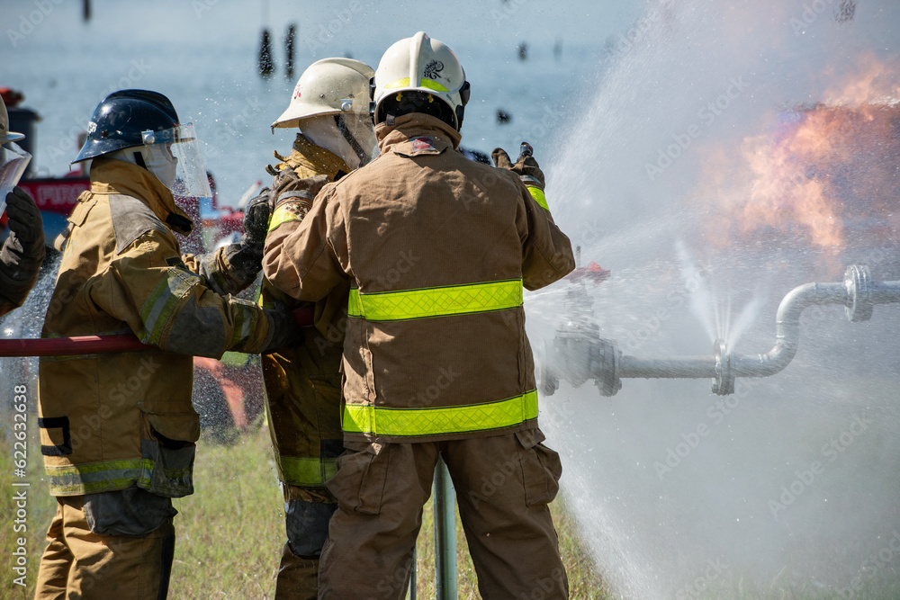 Firefighters and rescue training. Firefighter spraying high pressure ...