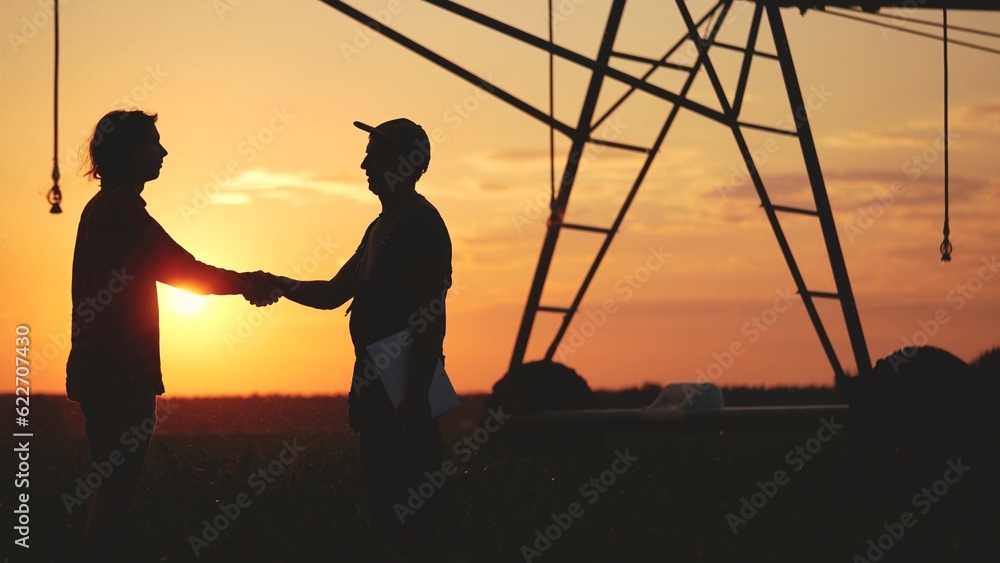 handshake agriculture. silhouette two farmers sign a contract shake ...