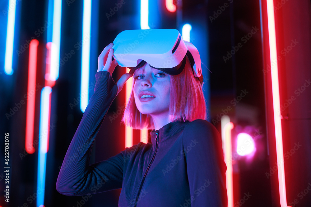 Woman in futuristic costume. Girl in glasses of virtual reality while ...