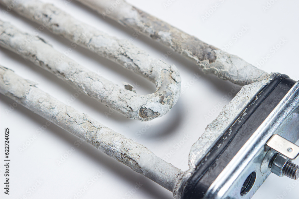 Damaged heating element for a washing machine on a white background ...