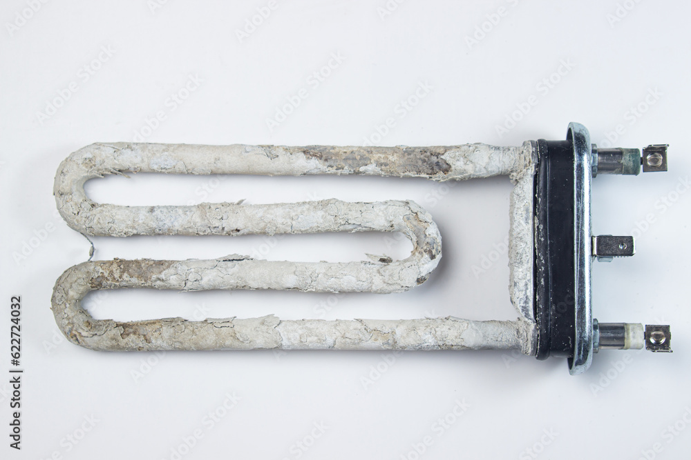 Damaged heating element for a washing machine on a white background ...