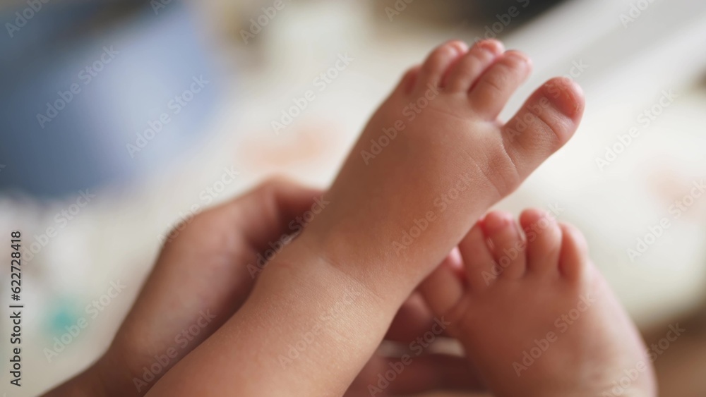 baby feet close up. dad holds a baby daughter legs in hands close-up ...