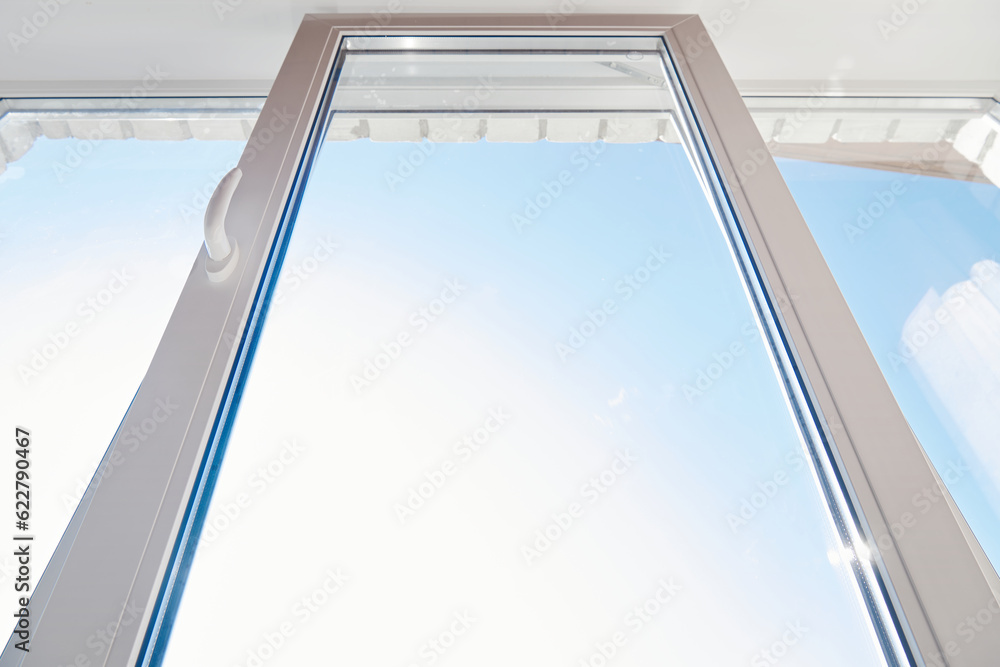 Opened plastic window frame for ventilation. PVC window. Tilted pvc ...