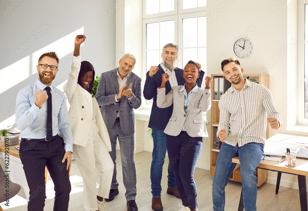 Happy multi ethnic business colleagues celebrating success in office ...