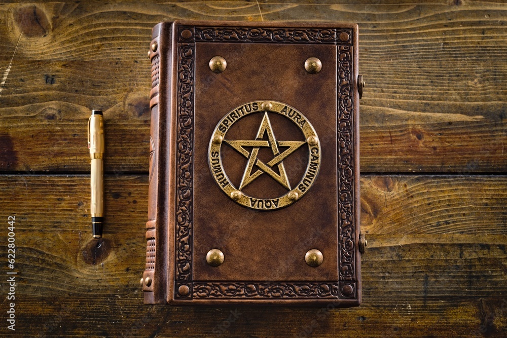 Aged leather book cover, design with the pentagram which contain ...