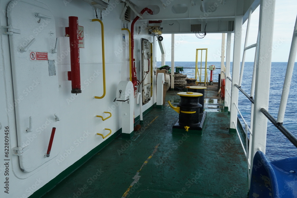 Entrance to white superstructure of container merchant vessel from main ...