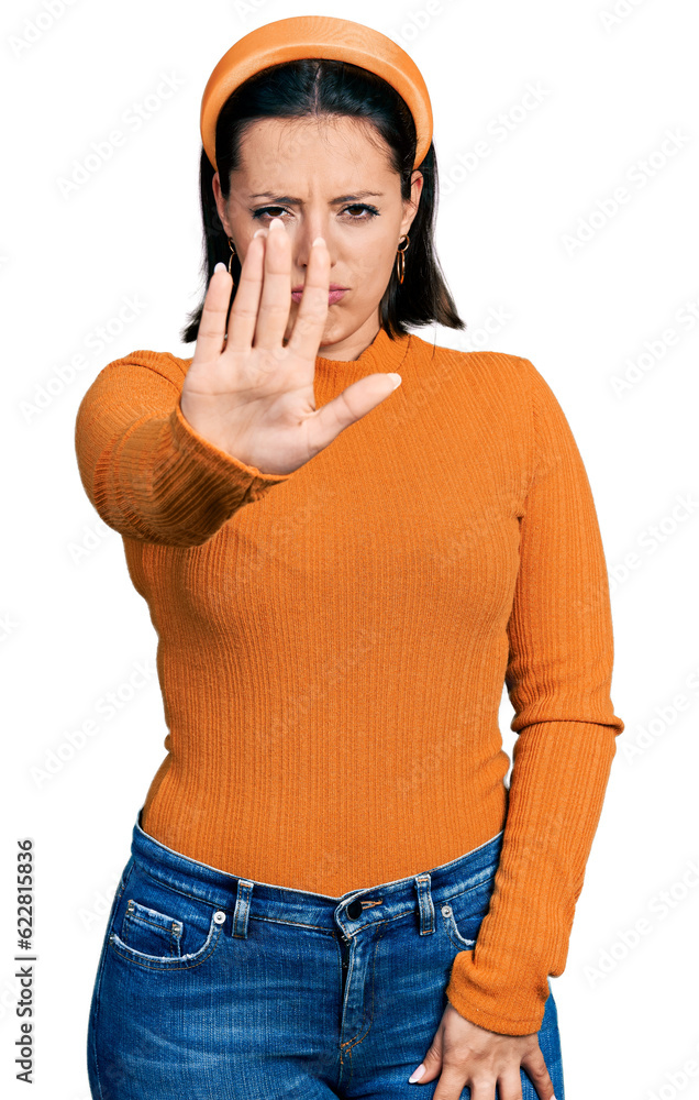 Young Hispanic Girl Wearing Casual White T Shirt Doing Stop Sing With