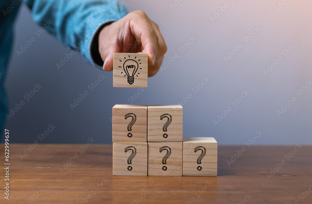Hand putting wooden cube block stacking which print screen light bulb ...