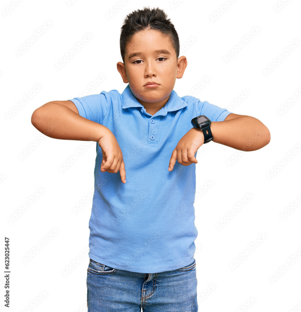Little boy hispanic kid wearing casual clothes pointing down looking ...