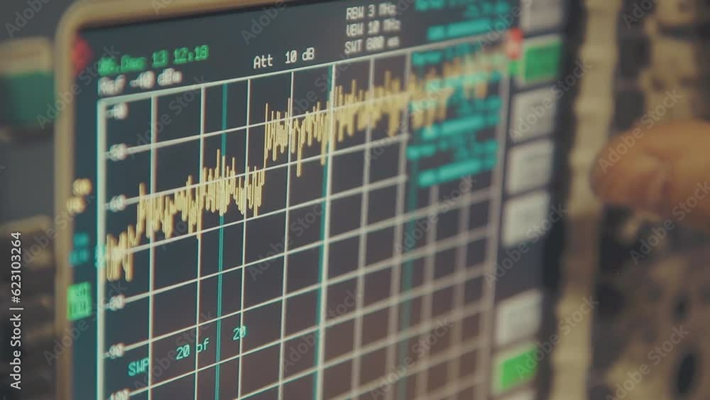 hand held close up shot of spectrum analyzer screen with megahertz ...