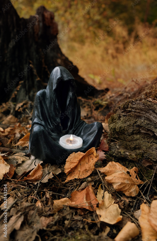mysterious black cloaked figure with burning candle in autumn forest ...