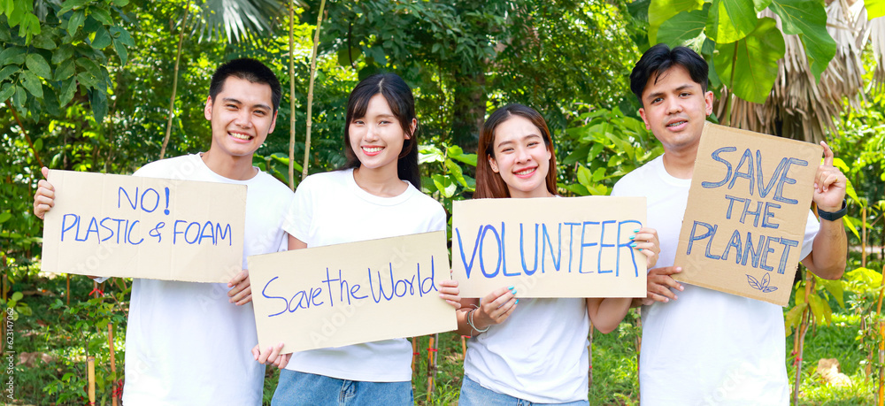 Group of young Asian volunteers holding signs supporting nature and the ...