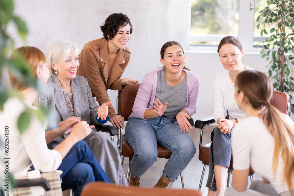 in group lesson, female middle-aged students are animatedly discussing ...