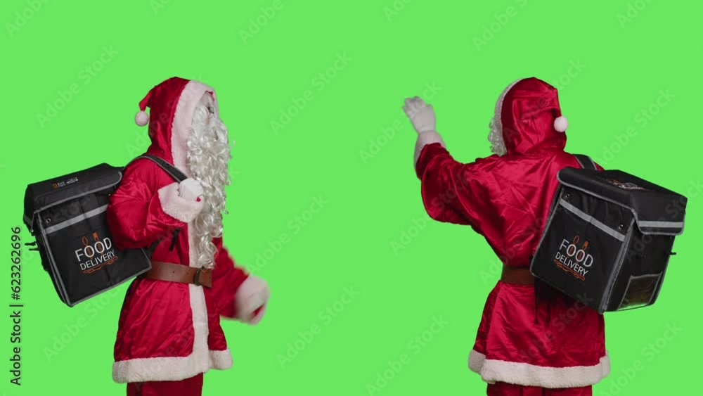 Man in santa suit with delivery backpack over greenscreen background ...