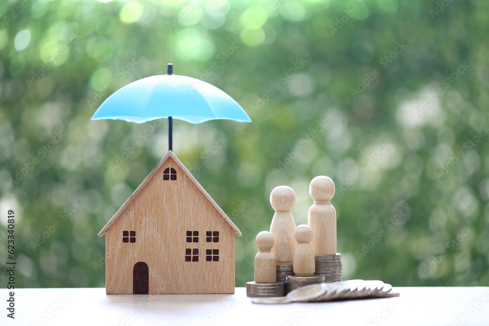 Protection,Model family with model house and stack of coins money on ...