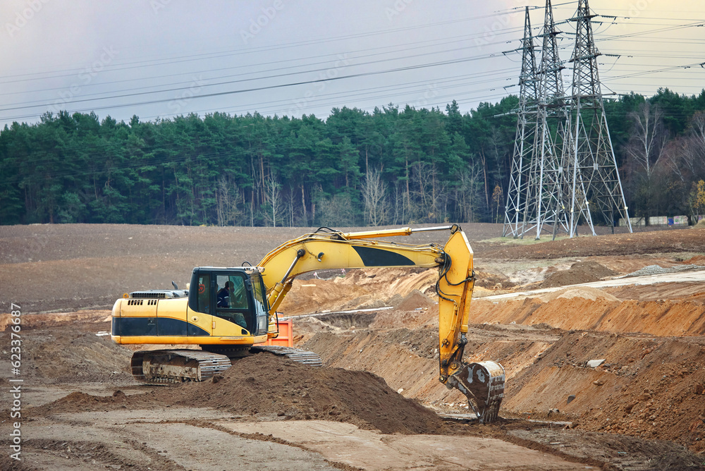 Foto de Excavator digging soil at construction site. Track-type loader ...