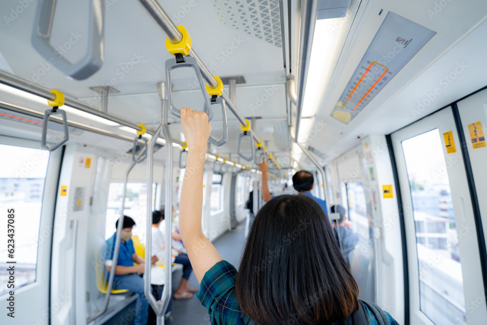 Woman hand firm grip safety handrail in elevated monorail train. Mass ...