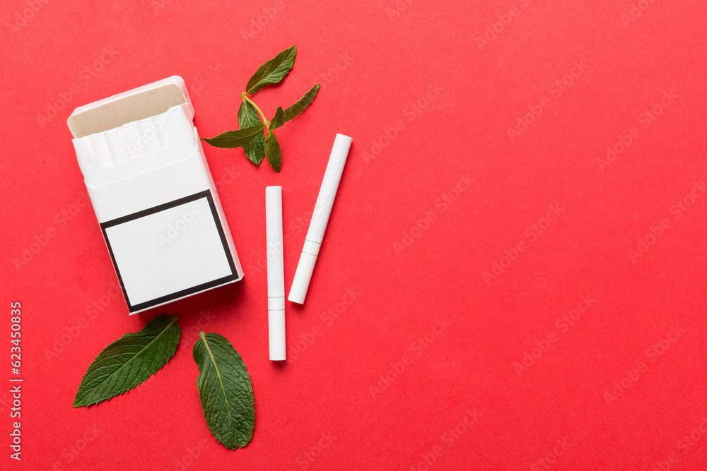 Pack of menthol cigarettes and fresh mint on colored table, Menthol ...