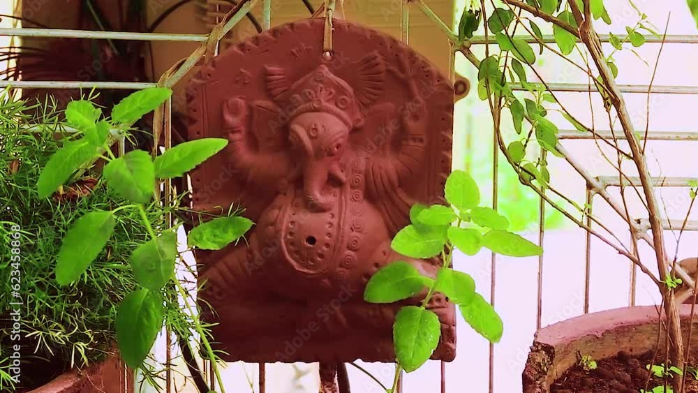 hindu god ganesha statue isolated at garden with tulsi tree for pray at ...