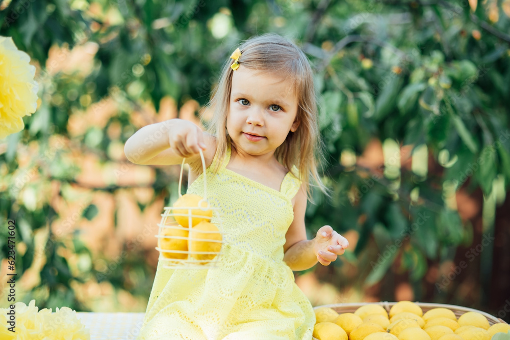 Little child girl with lemons at lemonade stand in park. Portrait of ...