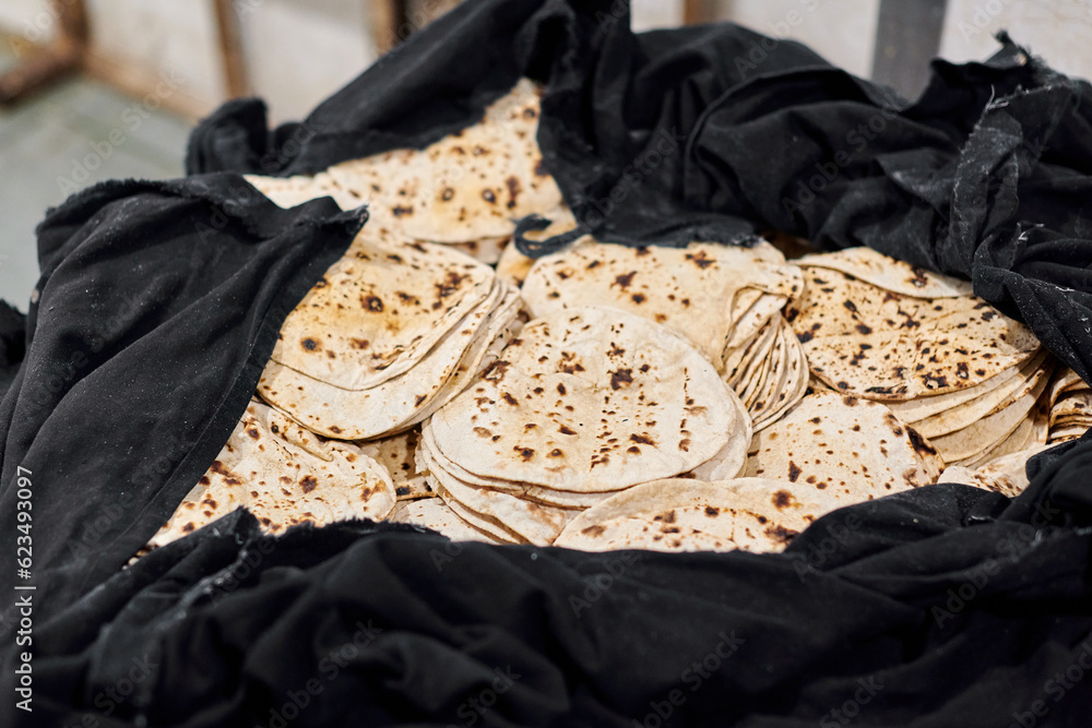 Batch of chapati round flatbreads in black bag for langar in sikh ...