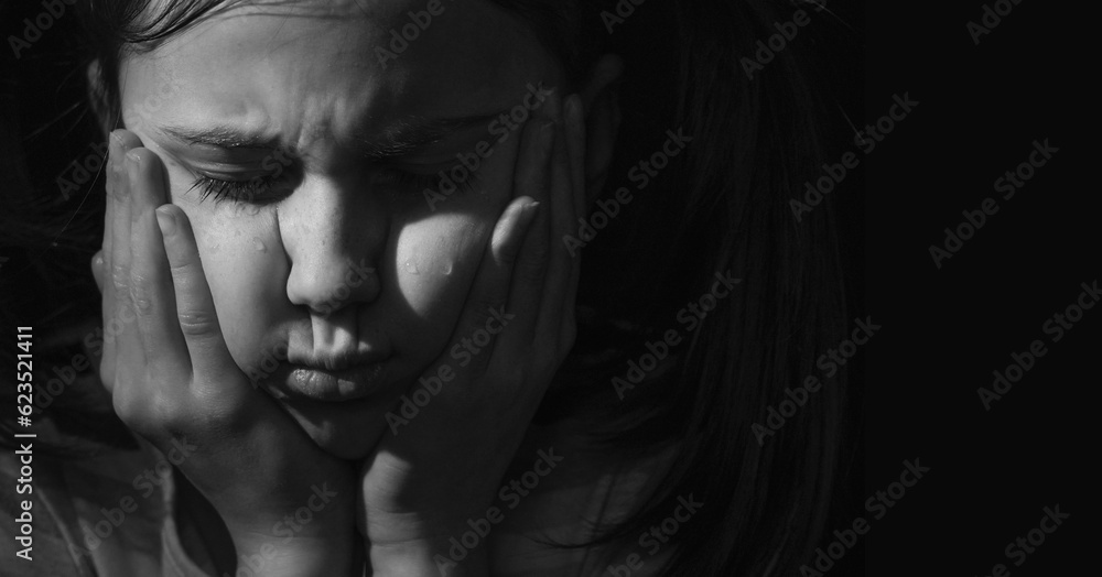 Children's tears and lost childhood concept. Close up dramatic portrait ...