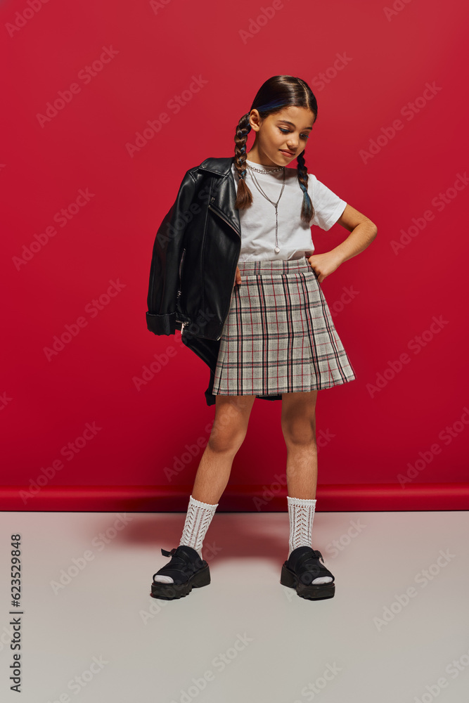Trendy brunette preteen girl with hairstyle posing in leather jacket ...