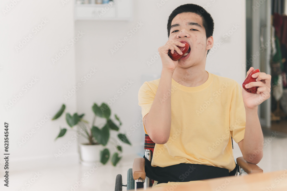 Asian young man holding the fruit in hand to learn to put food in his ...