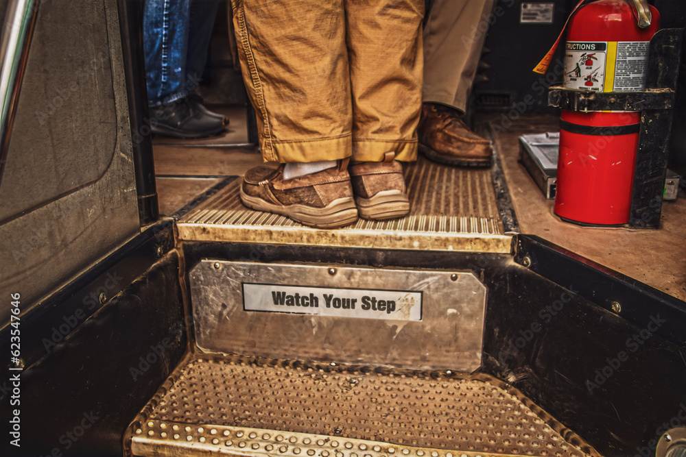 Foto de Boarding a bus - men's feet at top of steps reading Watch Your ...