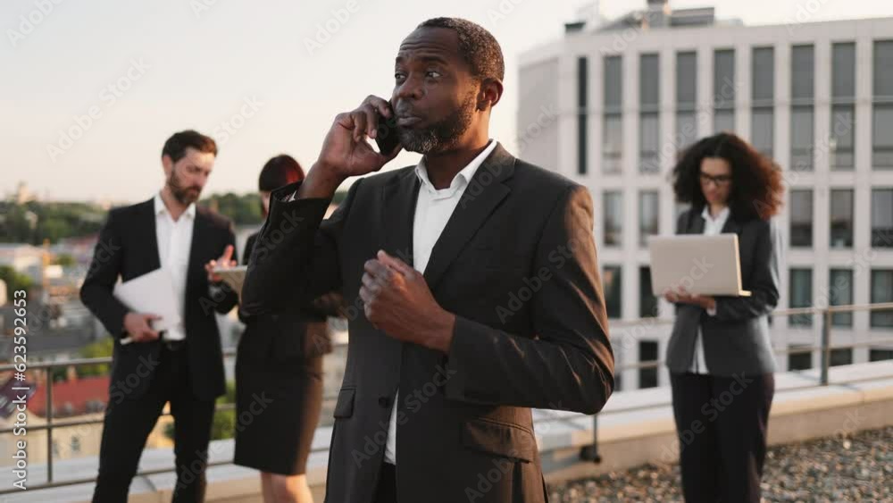 Beaming african american gentleman having conversation on smartphone ...