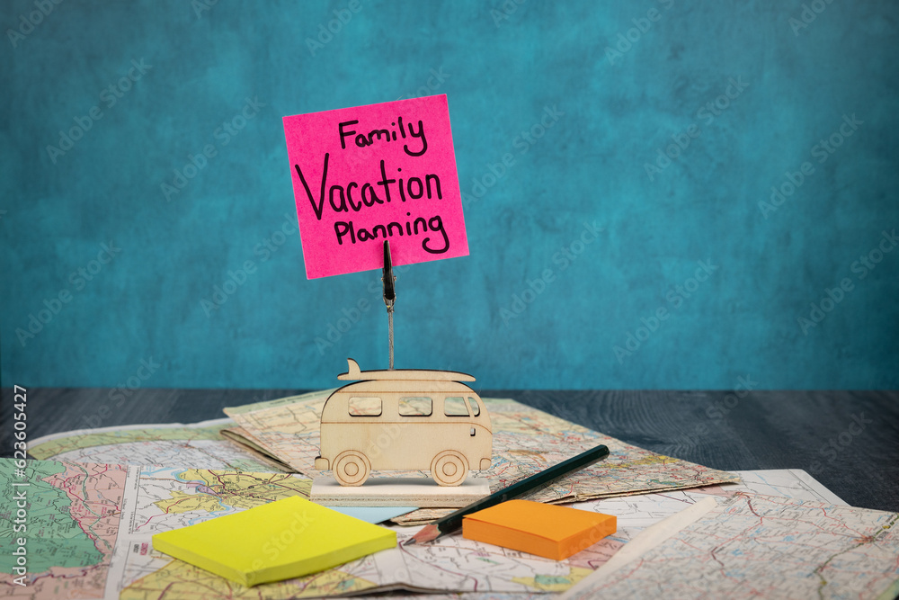 Family vacation planning handwritten on a posted note with old road ...