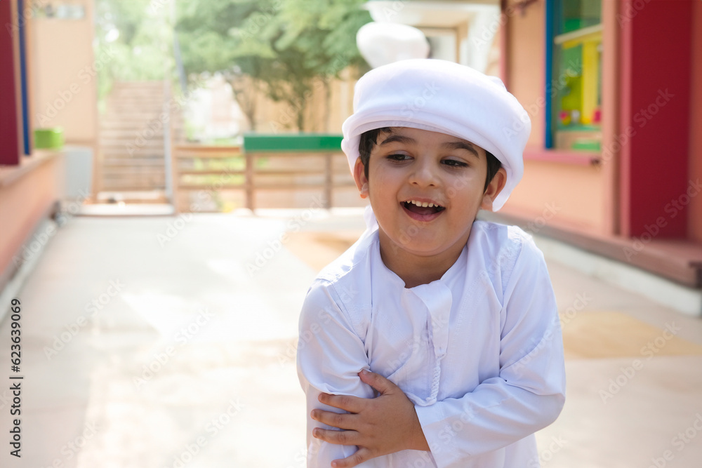 UAE Boy in Kandura at school campus. Dubai Student in dishdasha Stock ...