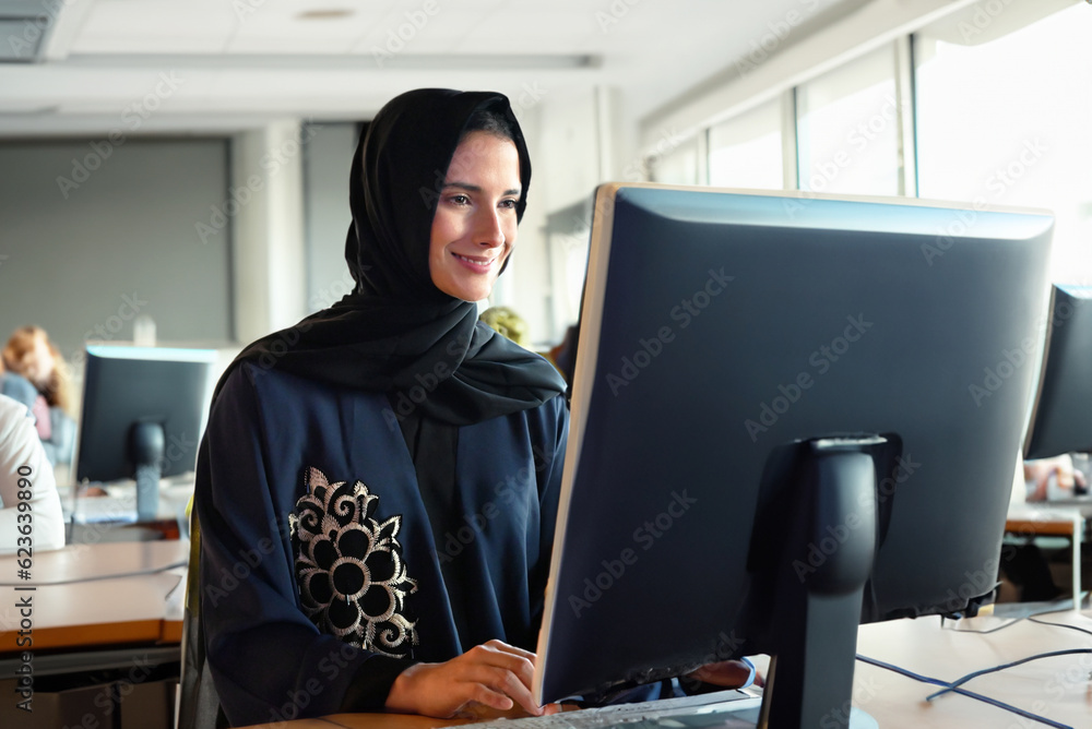 Student in Abaya at campus school using computer while at class. Arabic ...