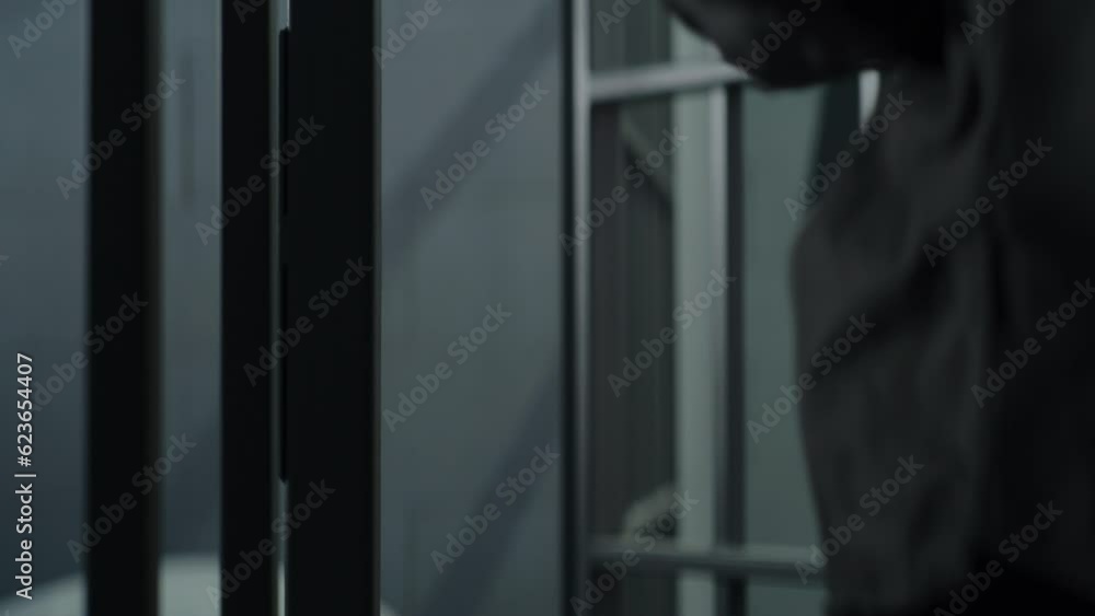 Close up of jailer opening and locking prison cell with keys. Prisoner ...