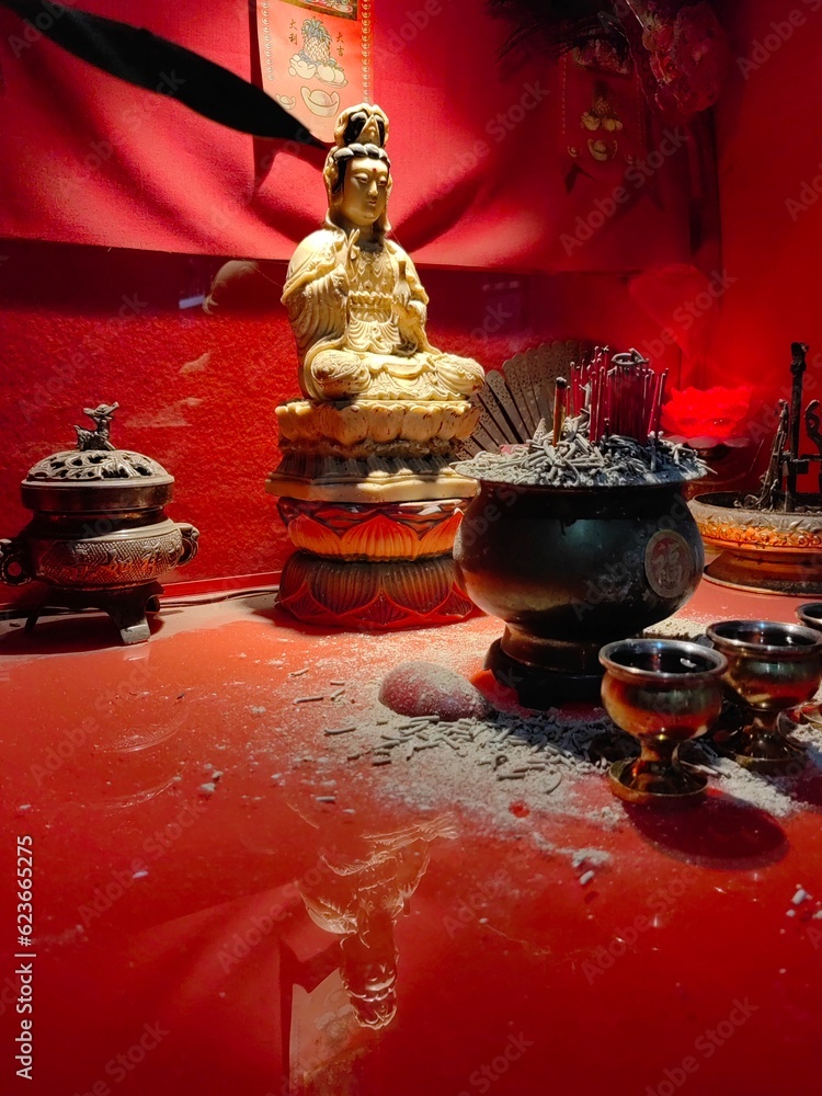 Statue of the goddess of compassion also called "Quan Yin" with shades ...