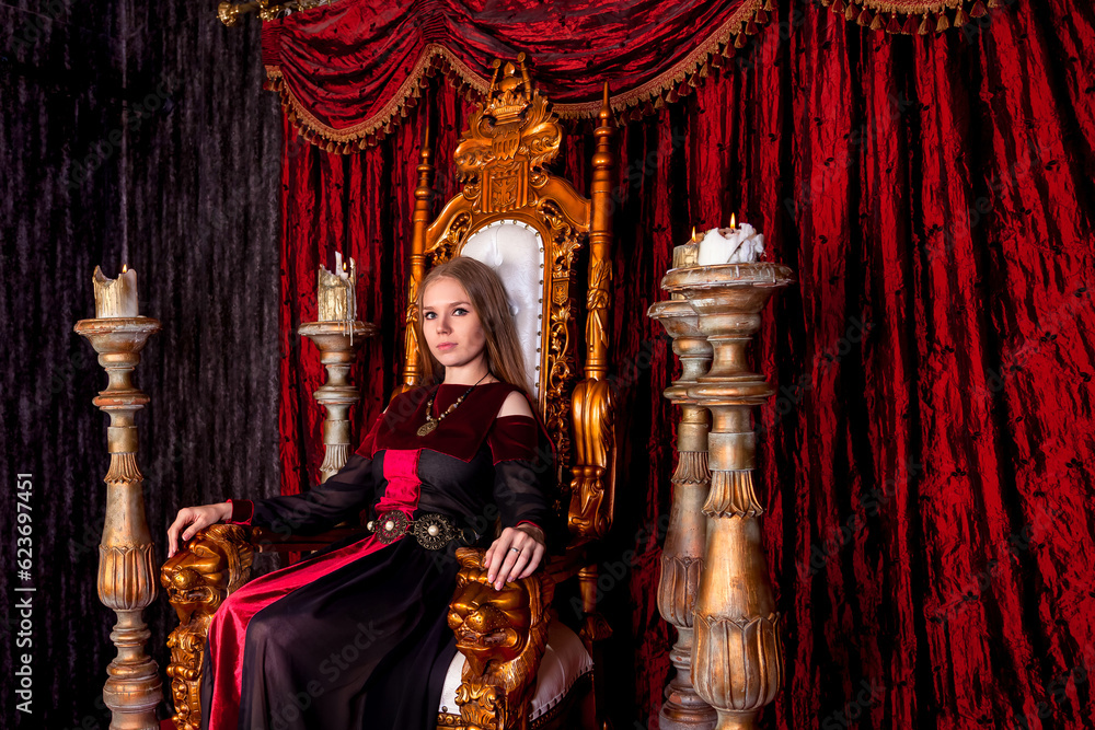 Lovely lady in an old style on antique throne fortress, looking at ...