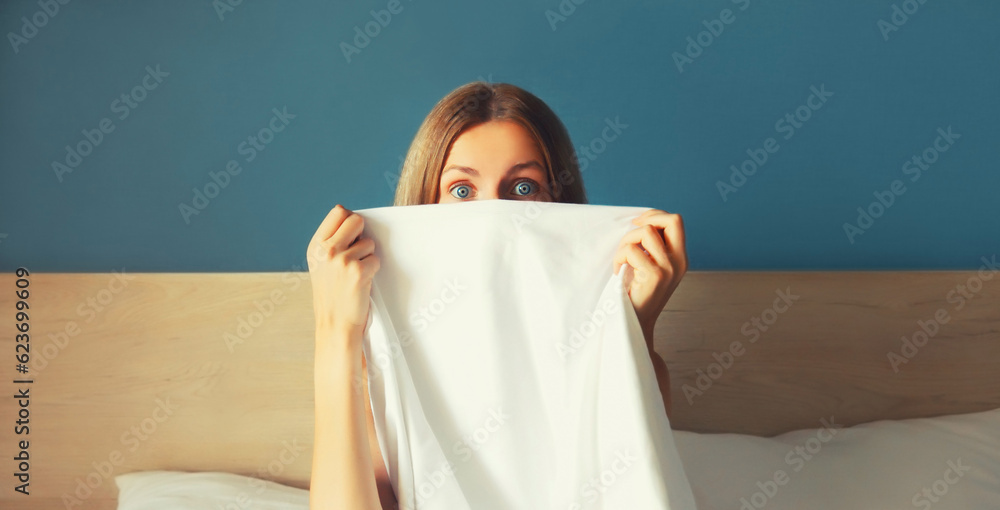 Surprised woman woke up late overslept work covering half her face with ...