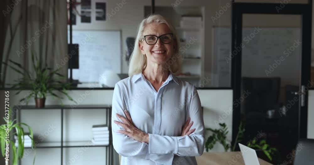 Positive senior mature business woman in glasses head shot portrait ...