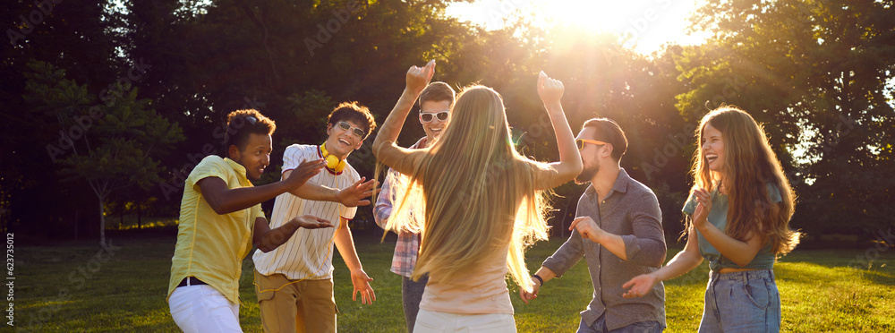 Carefree, cheerful young people having fun at an outdoor summer party ...