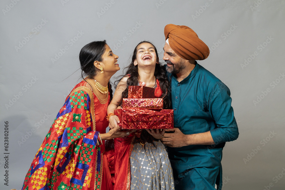 Poster Portrait of Indian family candid moment with gift ,Punjabi sikh ...