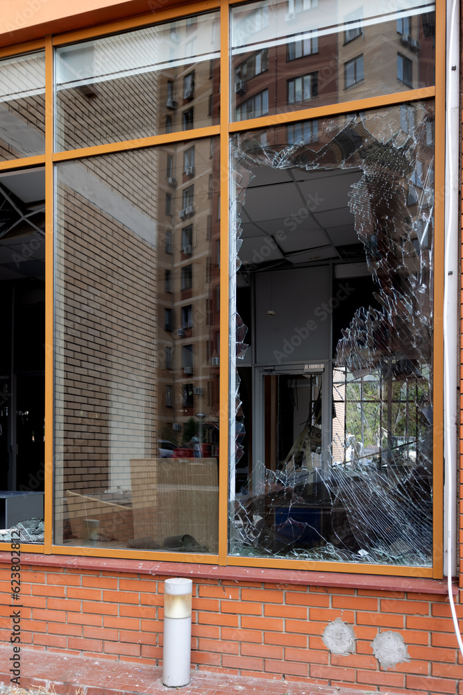 Broken windows of civilian building of bomb explosion. Shards of glass ...