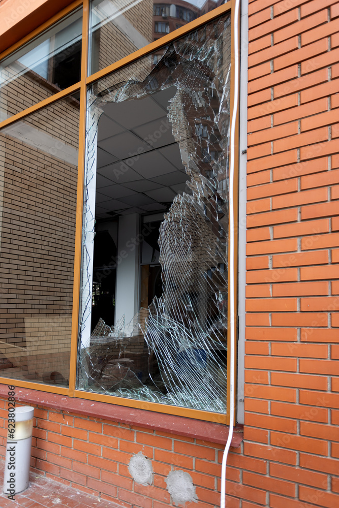 Broken windows of civilian building of bomb explosion. Shards of glass ...