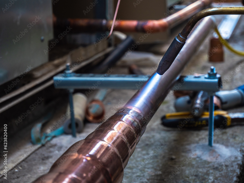brazing copper pipes with a gas torch Stock Photo | Adobe Stock