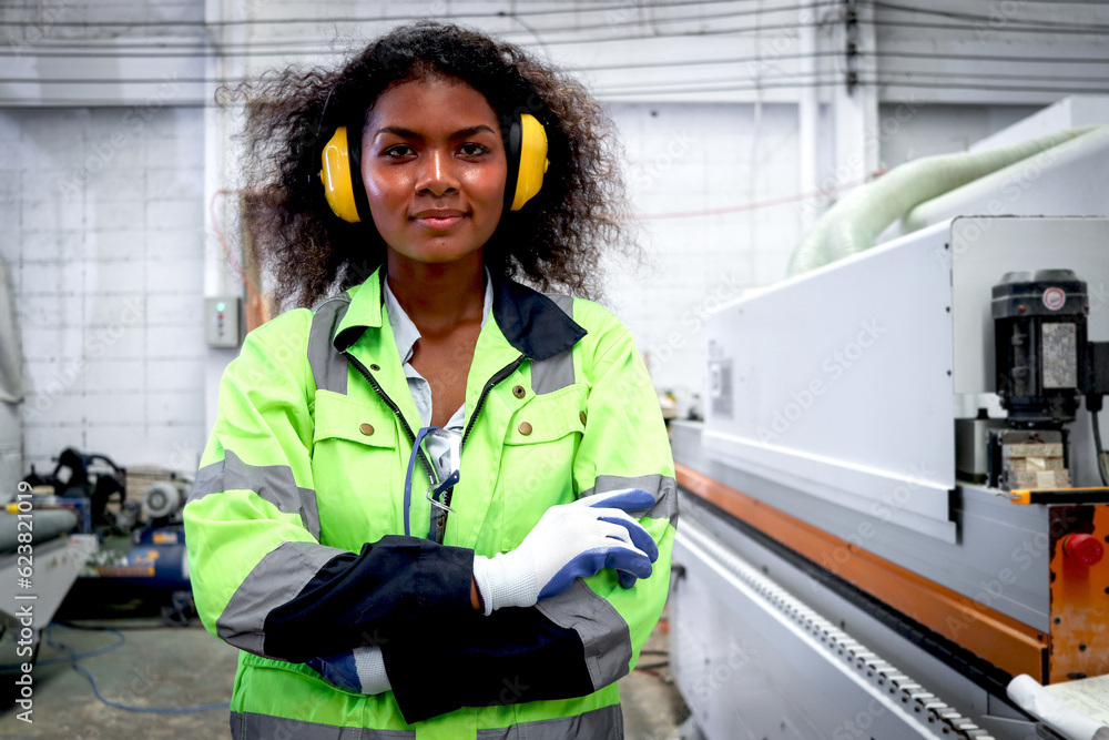 Portrait of happy African industrial woman worker with curly hair ...
